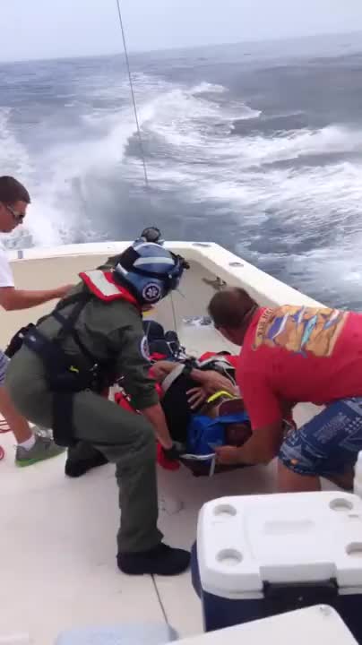 A man gets airlifted via helicopter off a fishing boat going full speed after suffering a heart ...