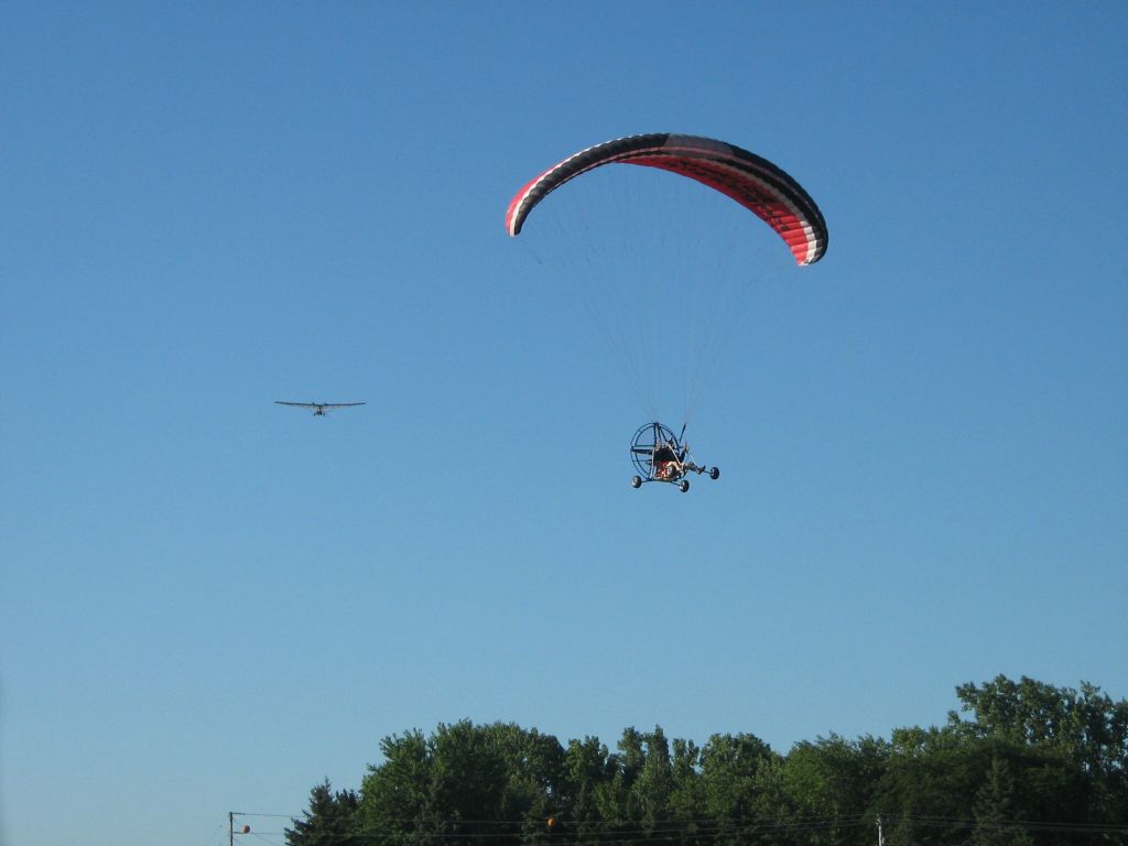 A Powered paraglider flying with Lazair ultralight at Oshkosh. | Scrolller