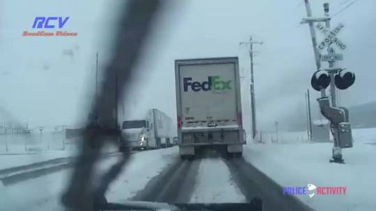 A train hits a moving FedEx truck sending contents flying | Scrolller