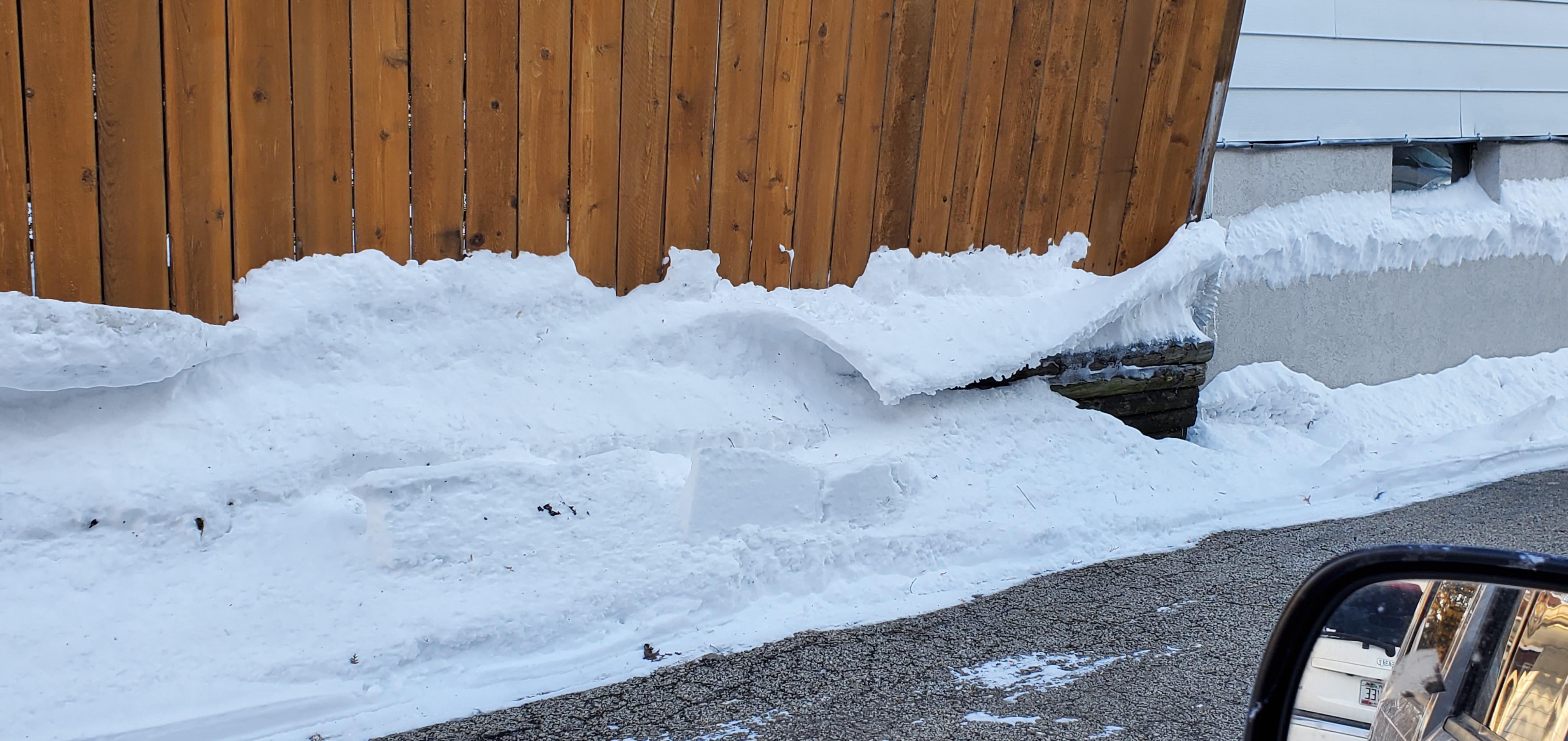 Buildup of snow on my neighbor's fence looks like a breaking wave. | Scrolller