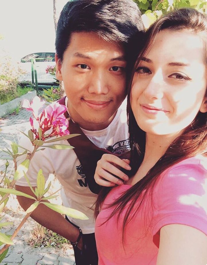 Chang likes the smell of her flower. | Scrolller