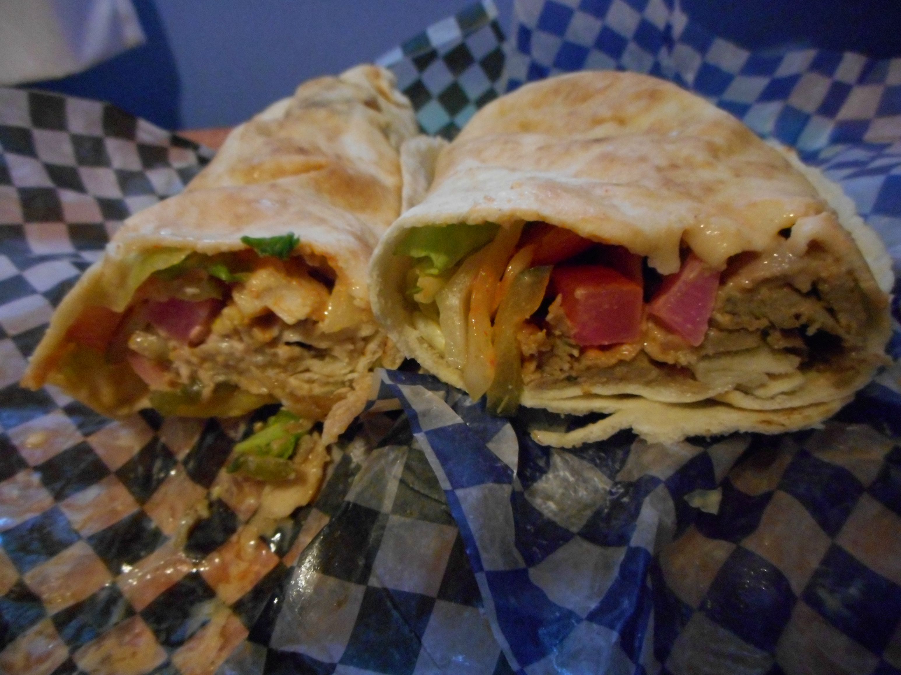 Chicen shawarma (left) and gyro (right) with lettuce, pickle, onion, tomato, turnip, hot peppers ...