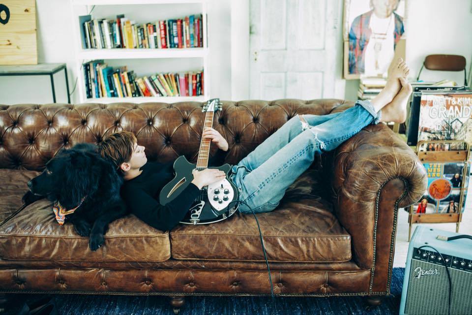 Chilling, playing a guitar | Scrolller