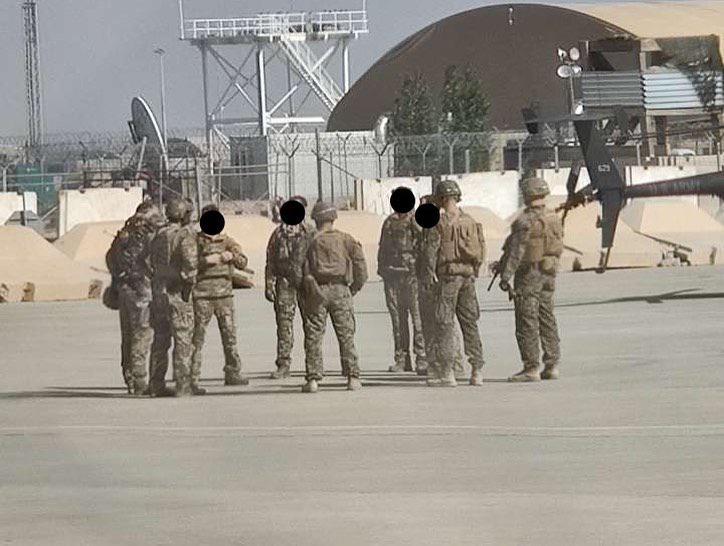 DEVGRU operators and Marines converse next to a 160th SOAR AH-6 at Bastion Airfield, Afghanistan ...