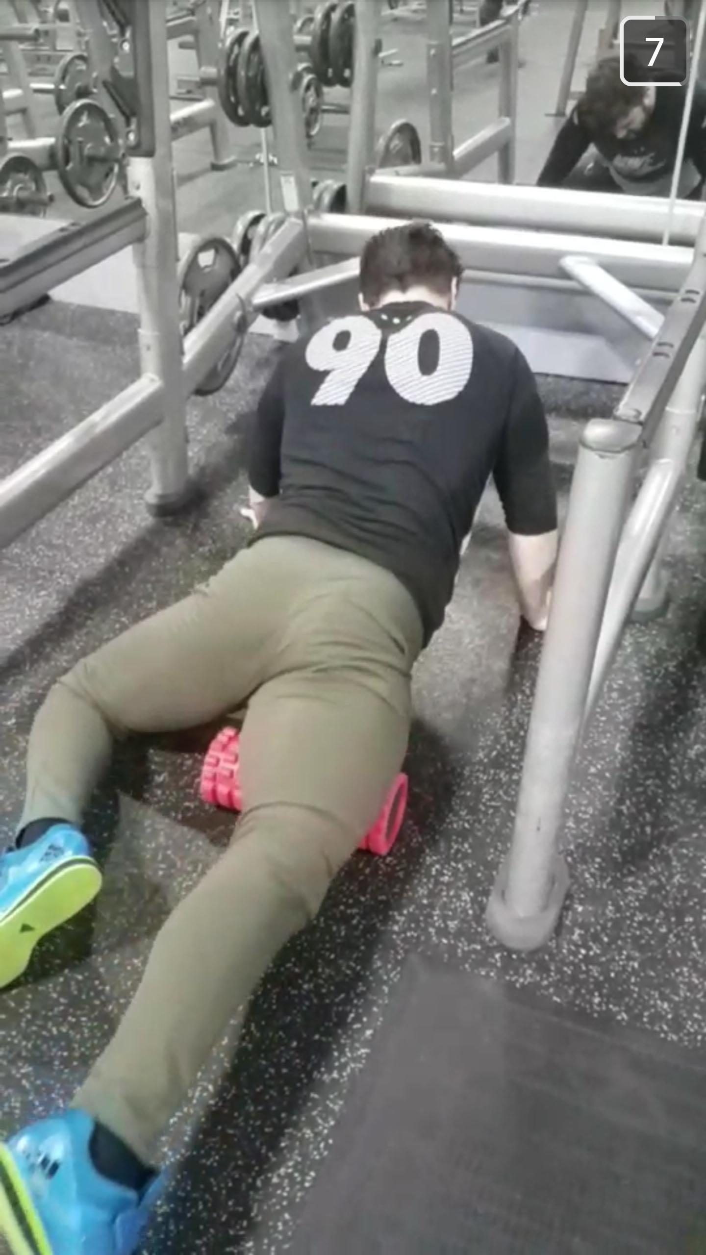 Foam rolling in the squat rack | Scrolller