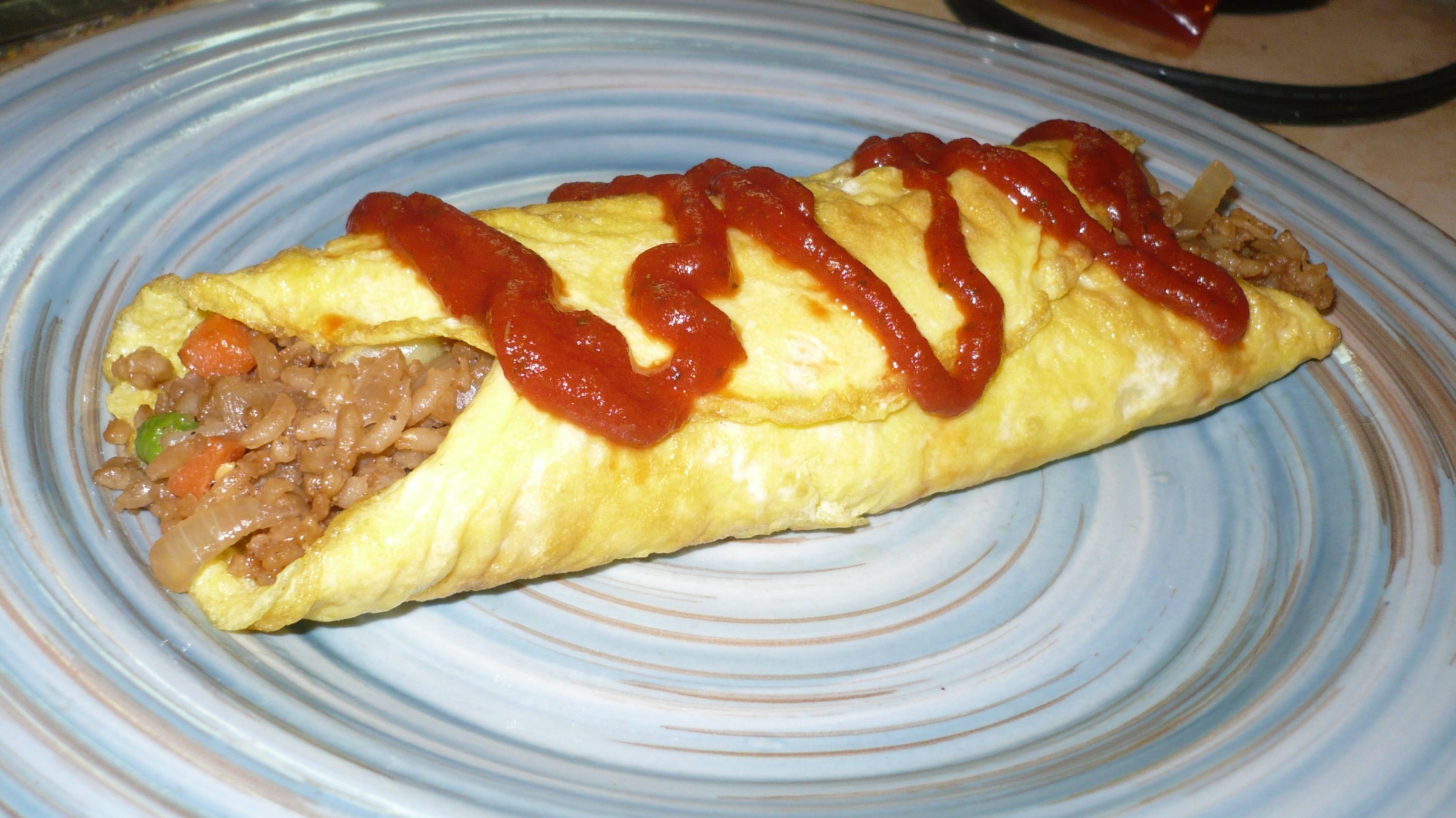 Fried rice wrapped in an omelet (omurice) | Scrolller