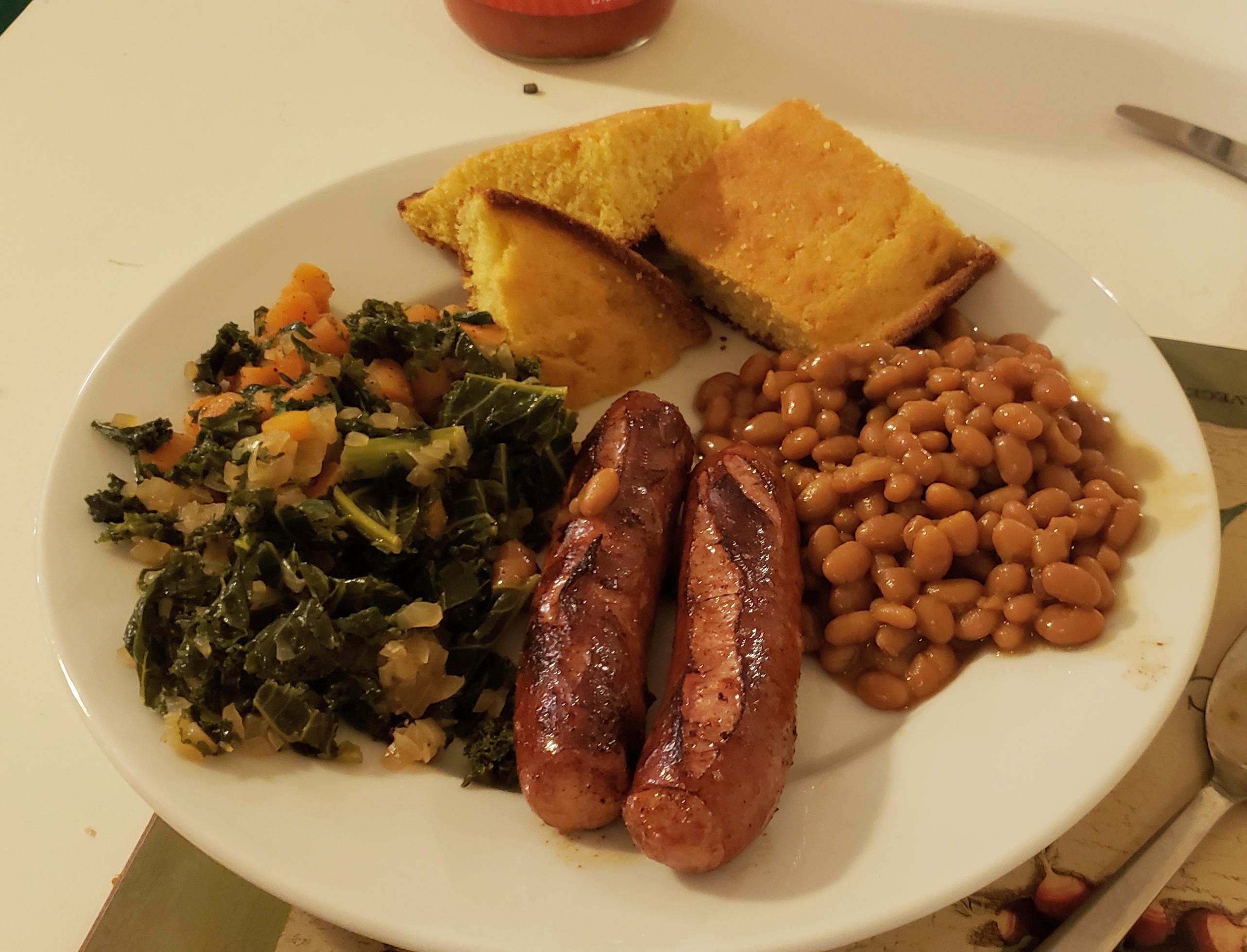 Homemade cornbread, smoked bratwurst, baked beans, braised kale and carrots | Scrolller