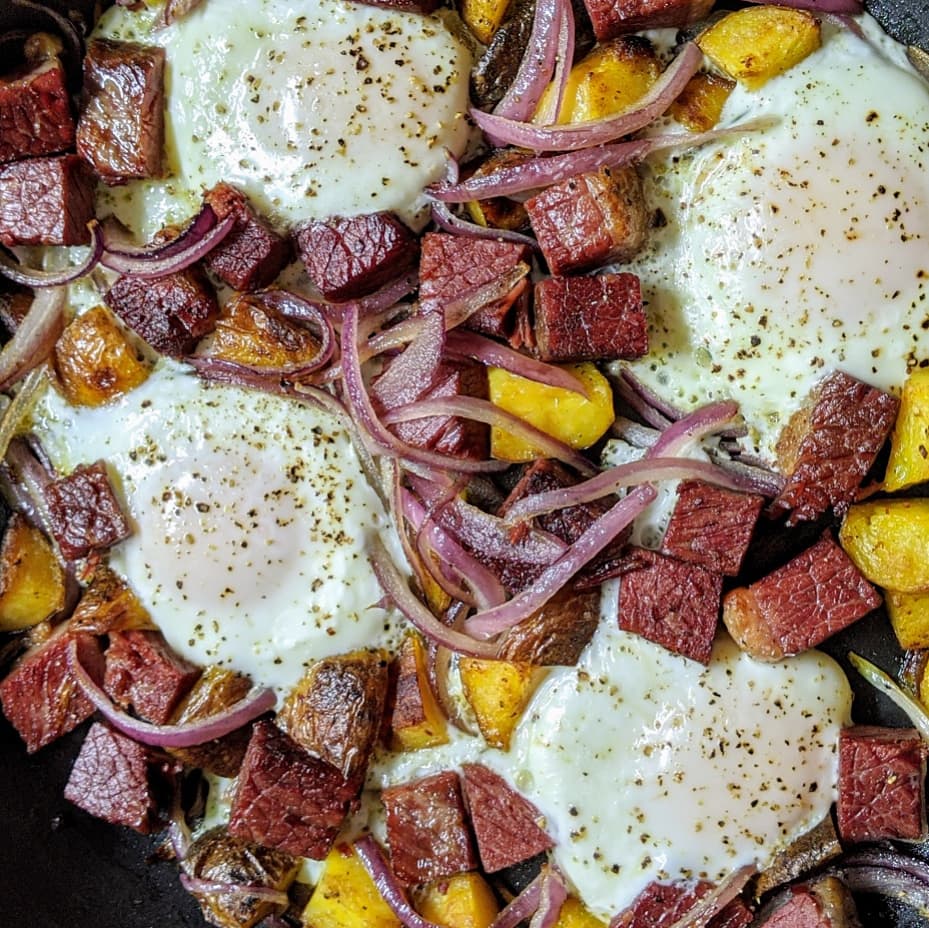 homemade corned beef hash with eggs over medium | Scrolller