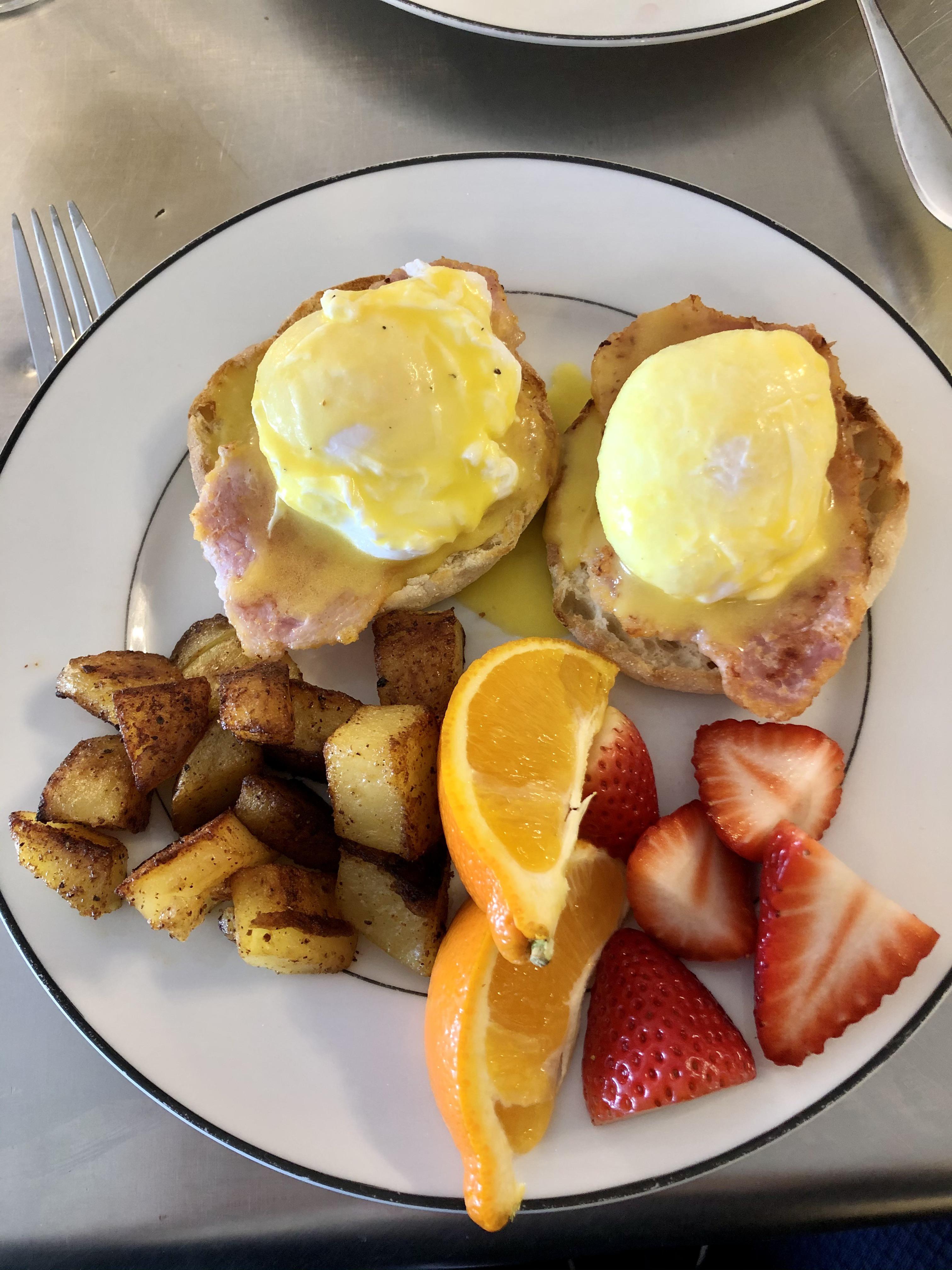 Homemade eggs Benedict with breakfast potatoes, and fresh fruit. First time ever making poached ...