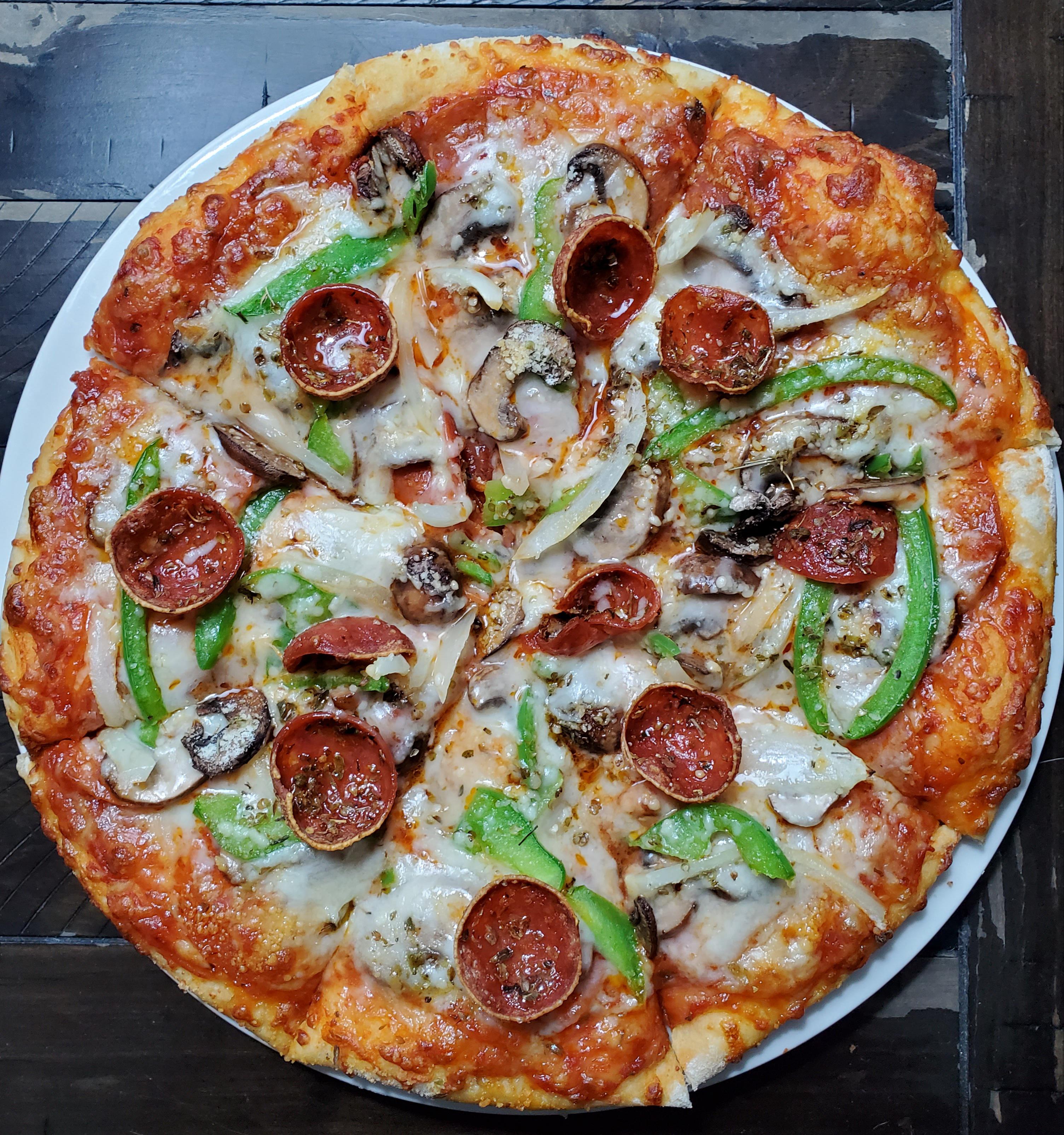 Homemade Pizza. Pepperoni, mushrooms, bell pepper and onions | Scrolller