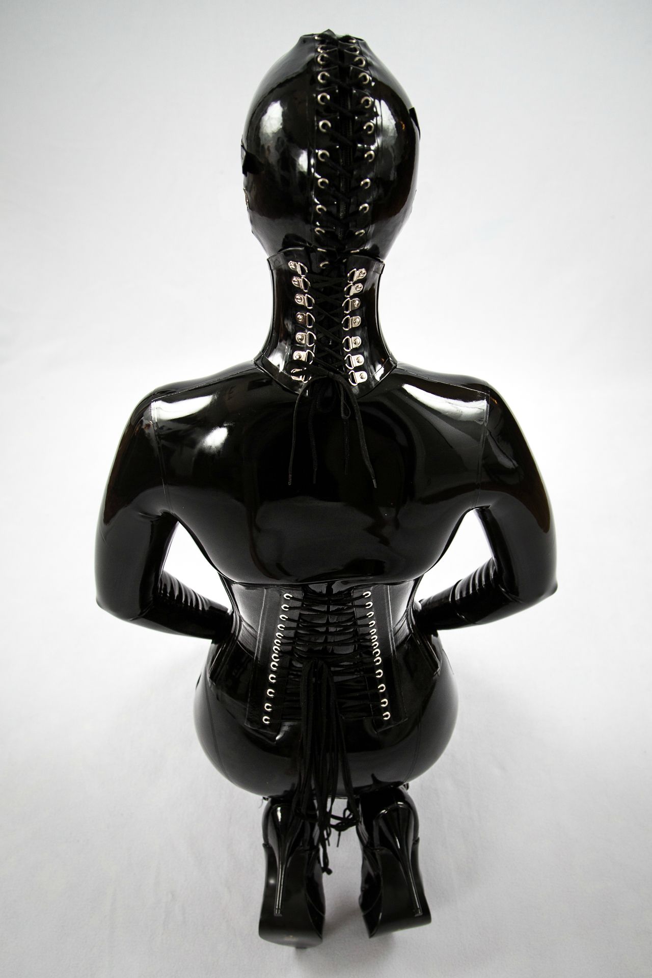 Hooded, corseted and laced tight | Scrolller