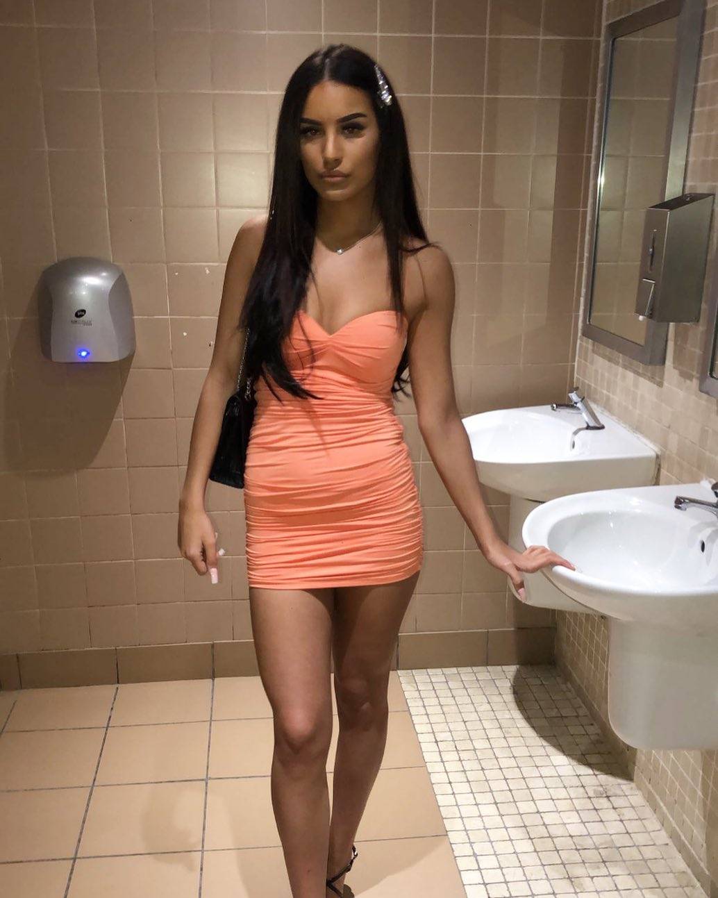 Hot little brunette in orange | Scrolller