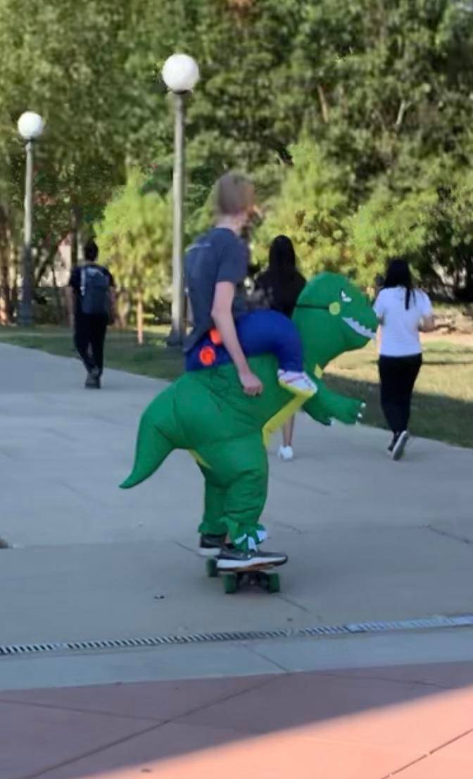 Just a man riding a t rex riding a skateboard by Grainger | Scrolller