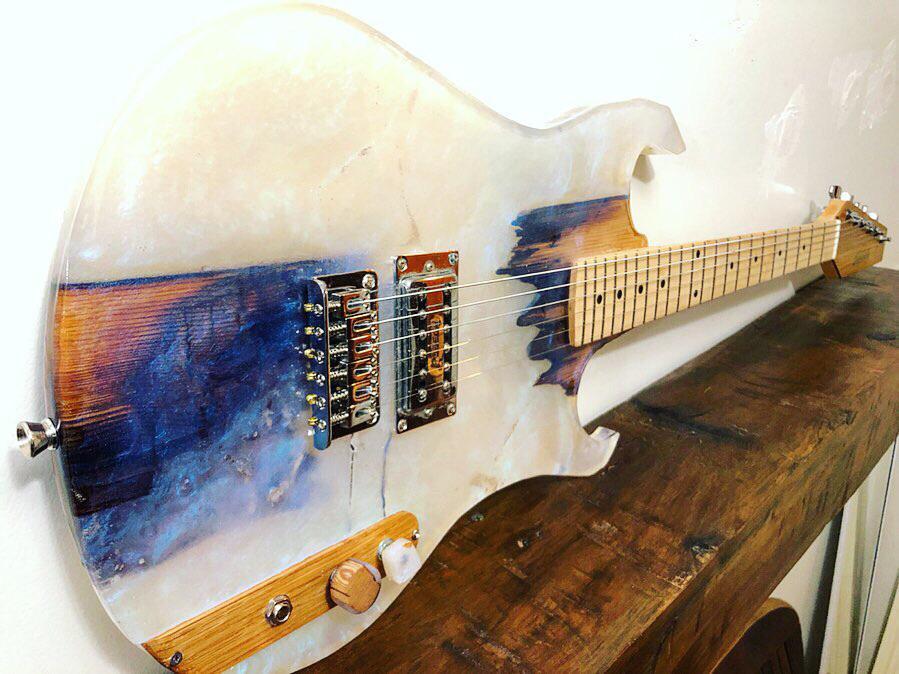 Just finished up this reclaimed wood and epoxy guitar. Second build ever, still learning a lot ...