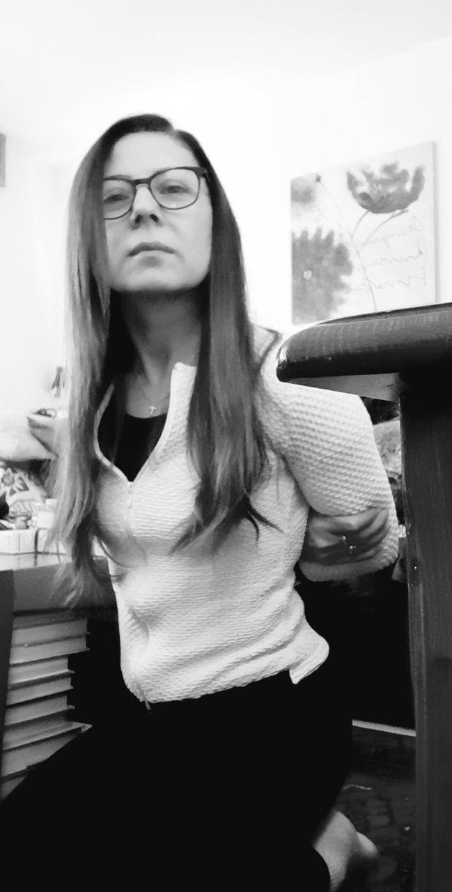 Mature lady prays with arms crossed behind back | Scrolller