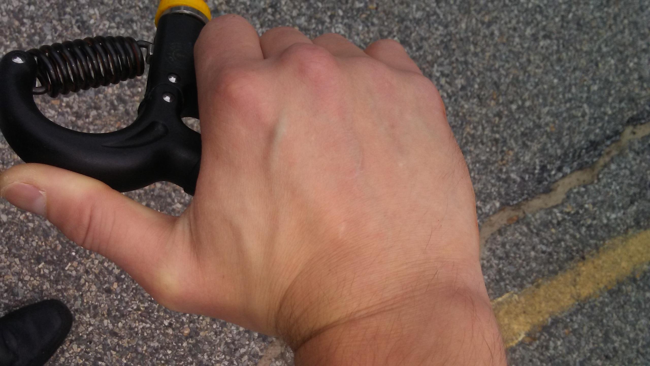 Me effortlessly squeezing a 90lb grip. | Scrolller