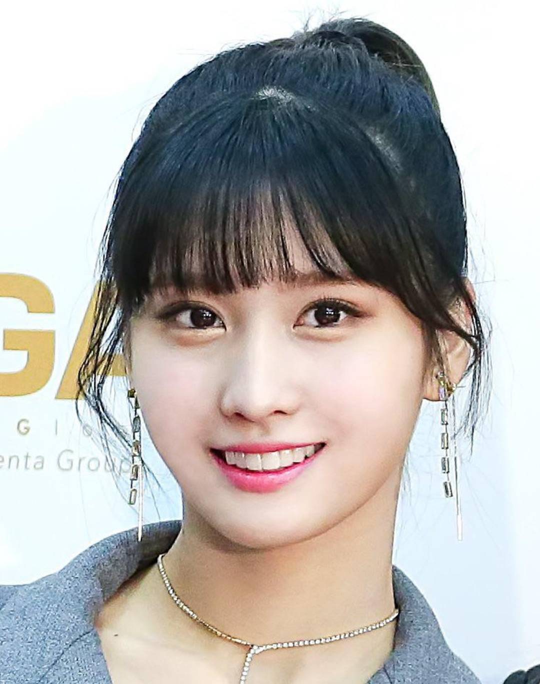 Momo - close up, grey suit jacket | Scrolller