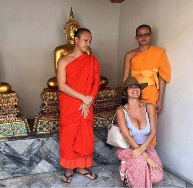 Monks standing near a woman | Scrolller