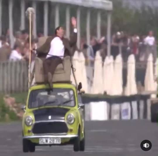 Mr Bean riding atop a car with his royal scepter | Scrolller