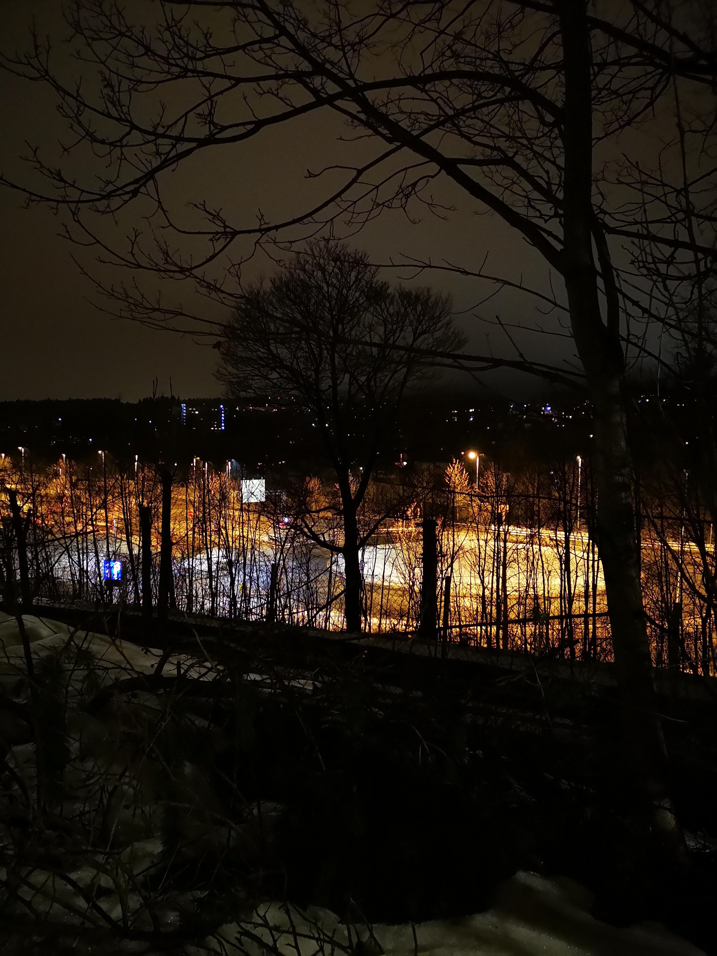 Nightwalk above empty lit up road | Scrolller
