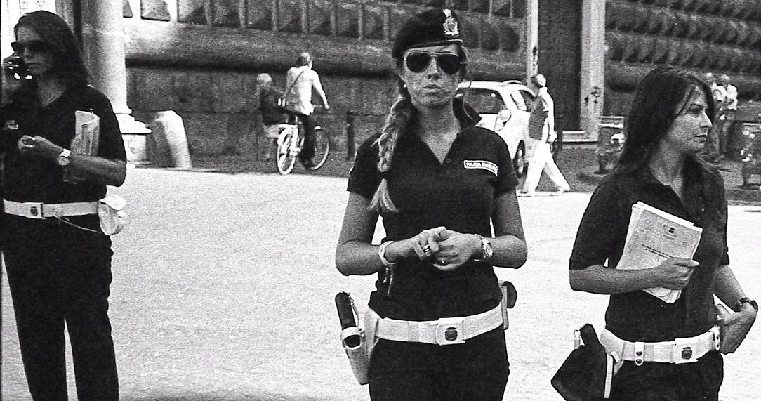 Policewoman with gun and sunglasses. Probably Argentina | Scrolller