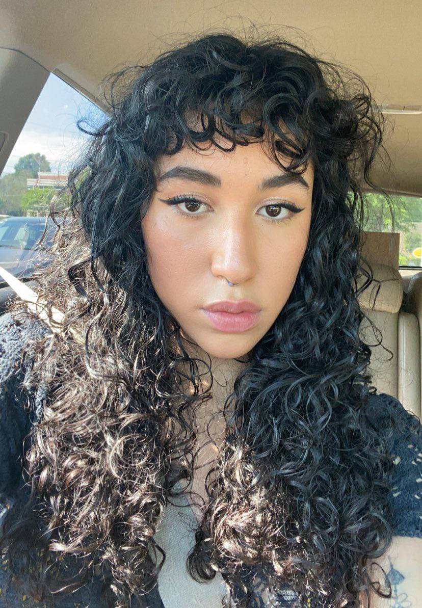 pretty face, plump lips, and curly hair | Scrolller