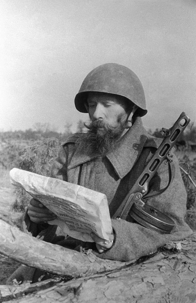 Red Army soldier Gavrila Lebedev reads a front-line newspaper. 1944 - Гаврила Лебедев читает ...