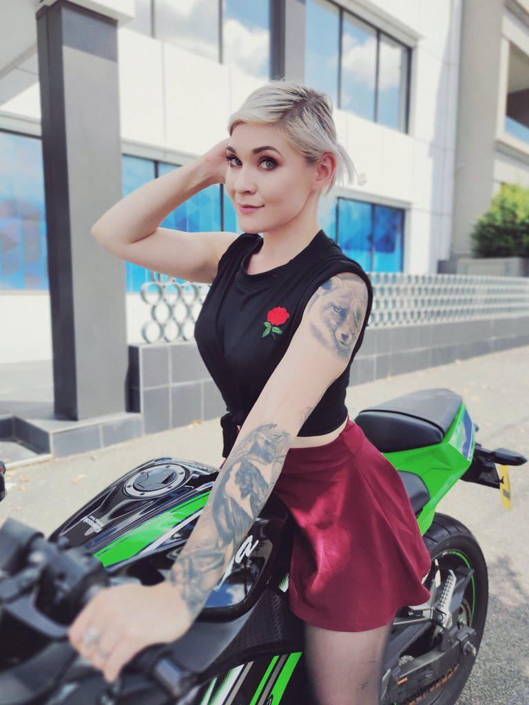 Short girl with short hair on oversized motorcycle. | Scrolller