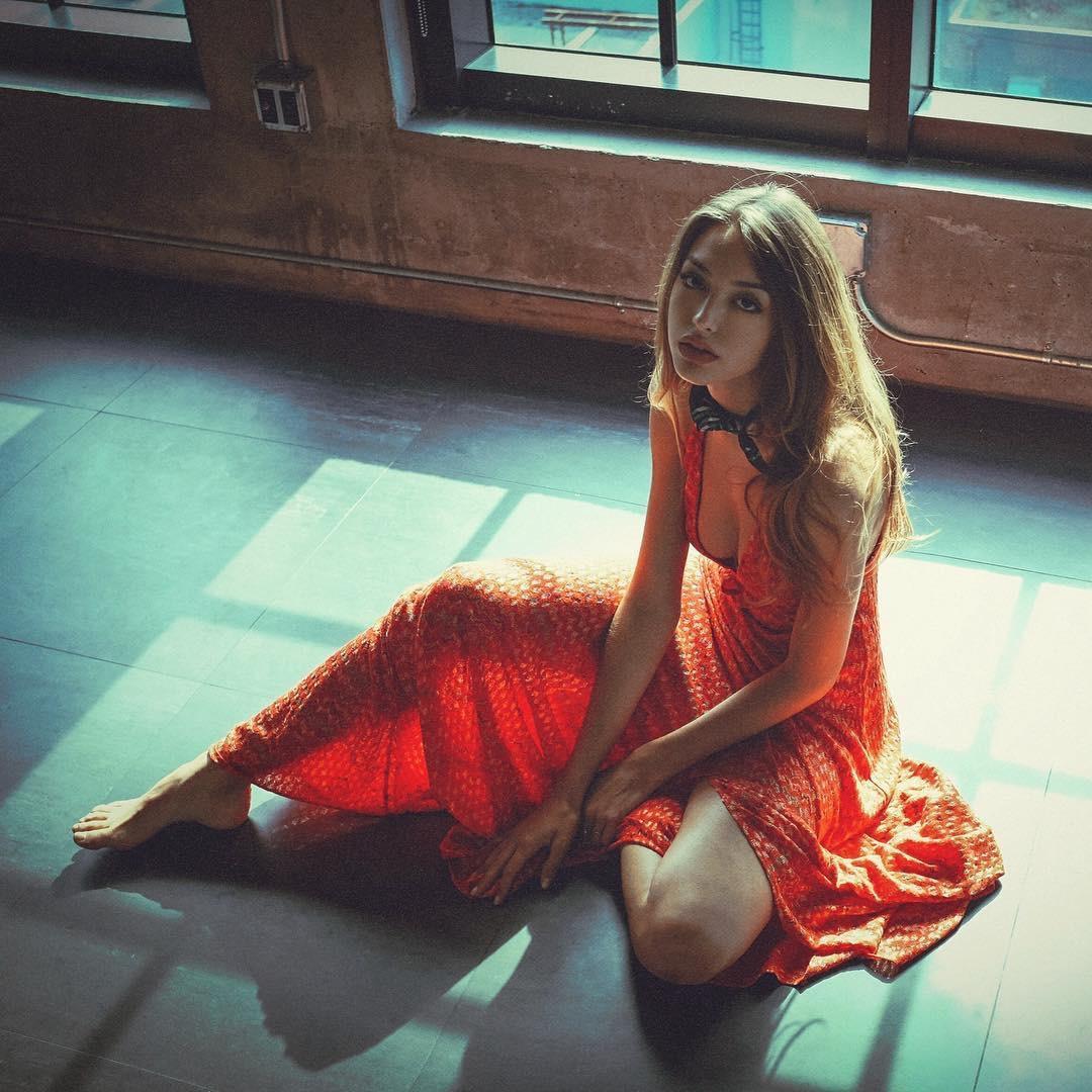 Singer Celebrity Celine Farach Orange By Window Scrolller