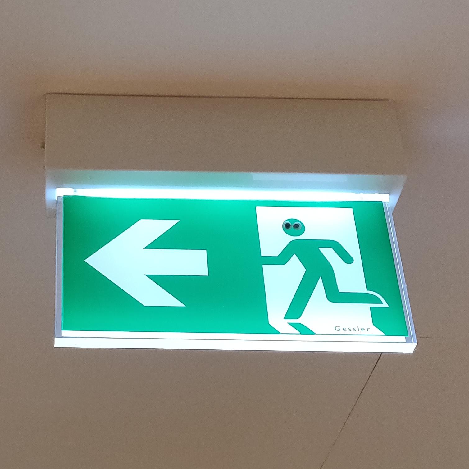 Someone put googly eyes on the emergency exit sign at my work. | Scrolller