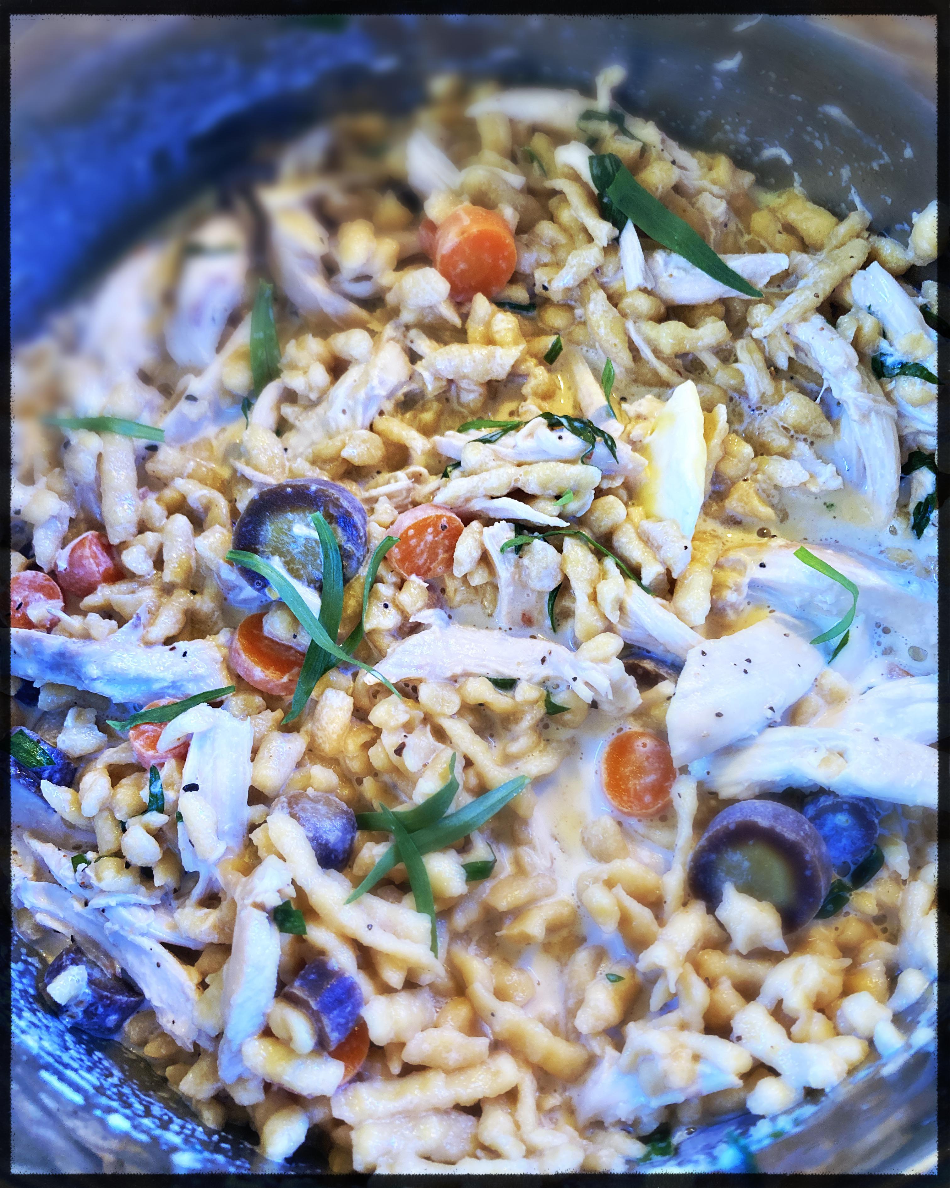 Spaetzle dumplings with chicken, heirloom multicolored carrots, in tarragon cream sauce. Comfort ...