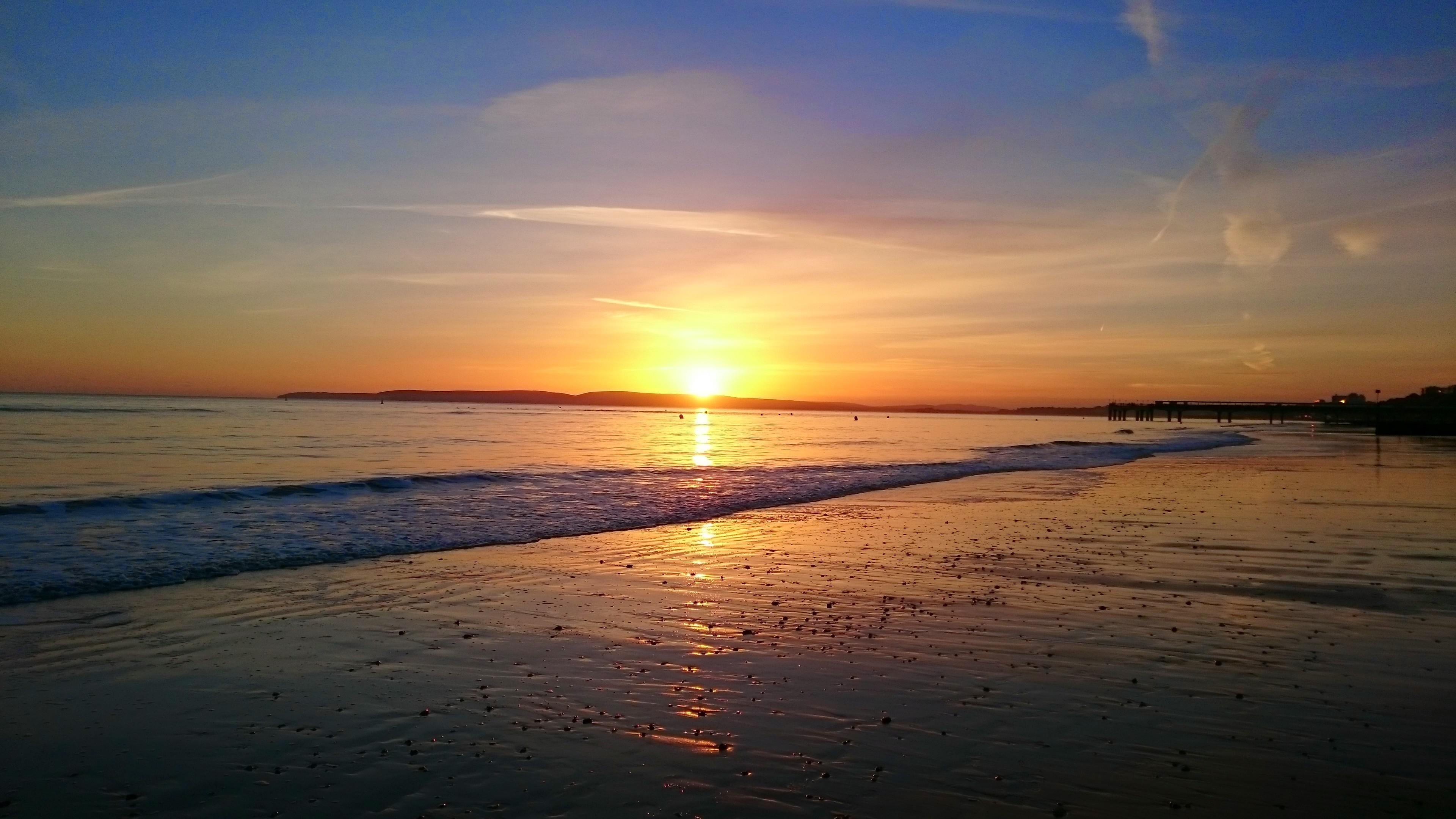 Sunset over the Purbecks from Bournemouth beach | Scrolller