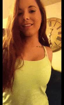 Taking off her tanktop then her bra. | Scrolller