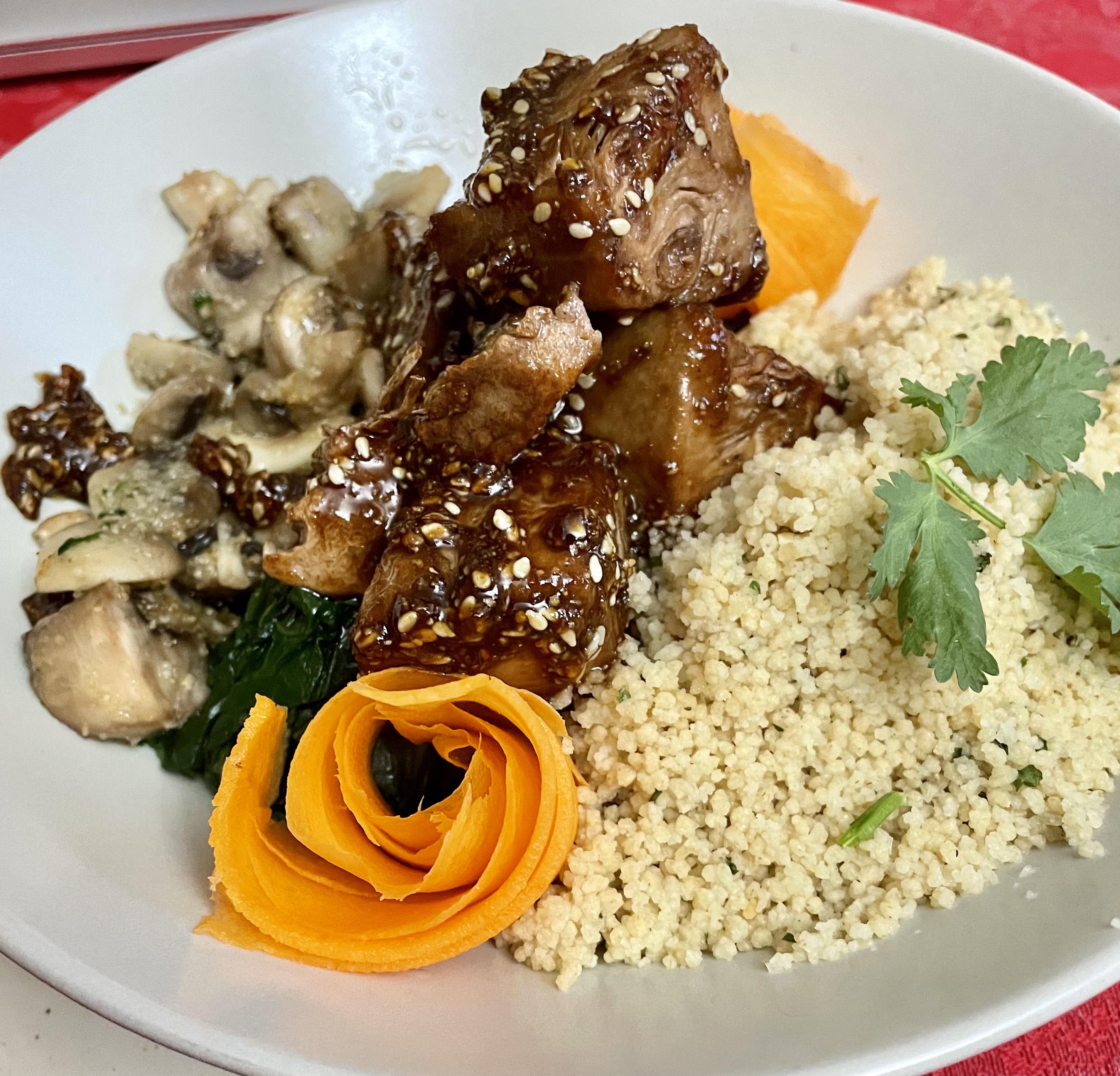 Teriyaki Jackfruit with couscous, spinach, mushrooms, and carrot roses | Scrolller