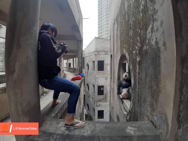 This is my photographer, and we're hanging on the ledge on the third floor to get window views ...