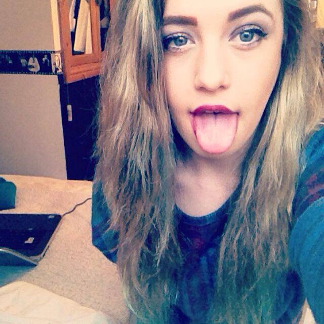 Tongue out on the bed | Scrolller