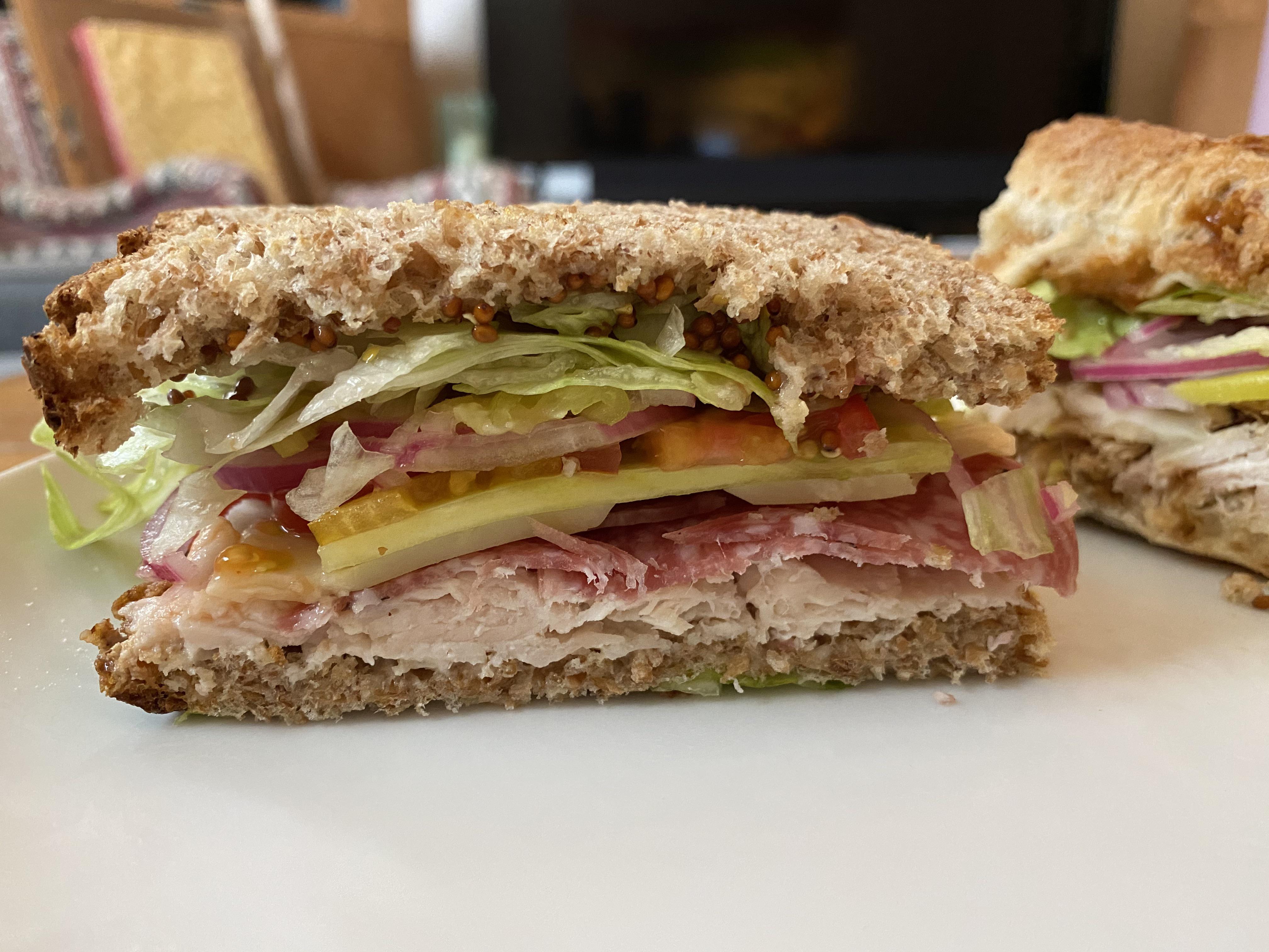 Turkey, salami, swiss, tomato, pickled onion, shredded iceberg, mayo and whole grain mustard on ...