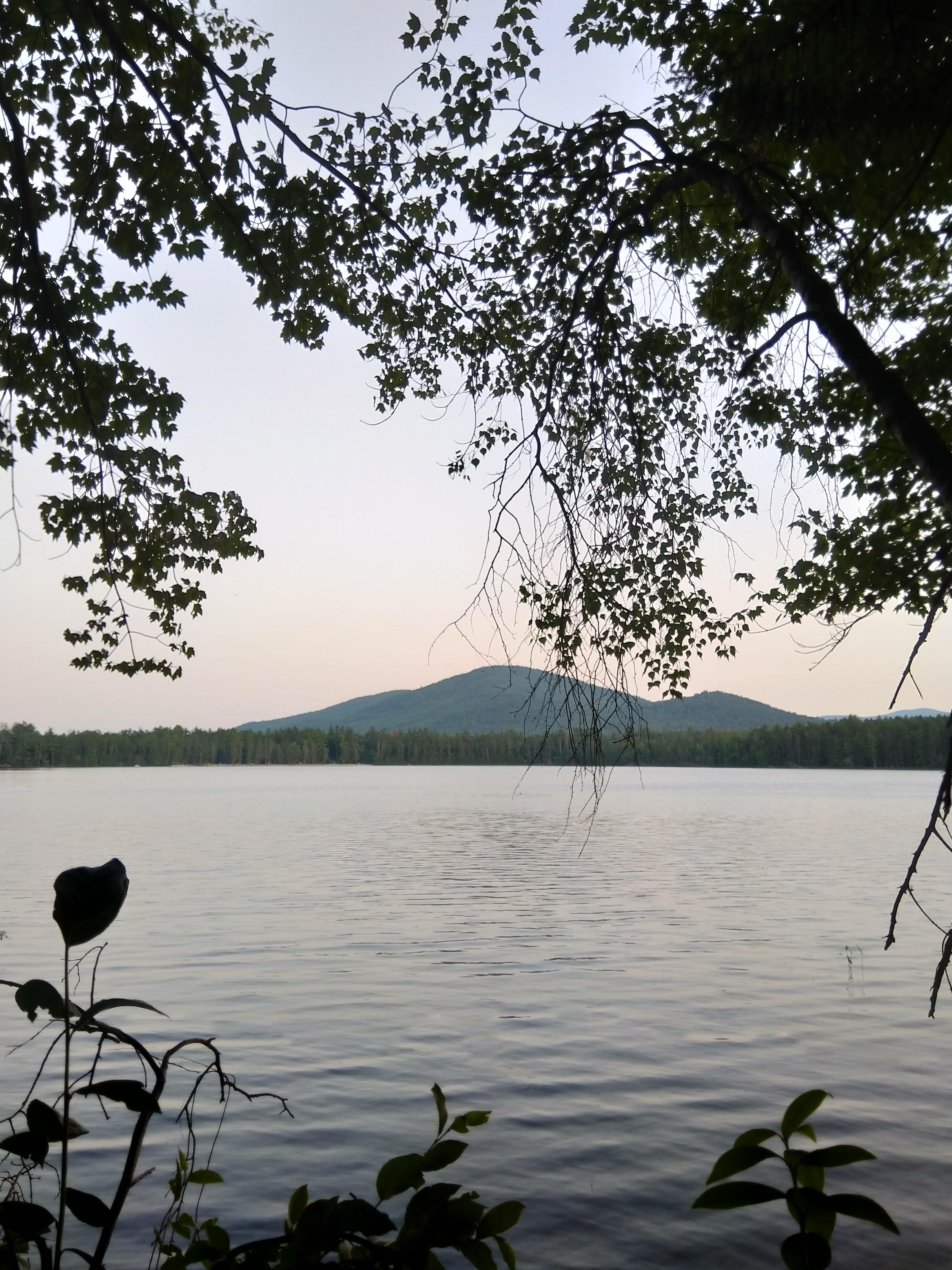 White Lake, a glacial lake in Tamworth NH. Mount Passaconaway in the ...