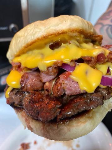 3-cheese smoked brat on top of a burger with red onion and bacon queso! | Scrolller