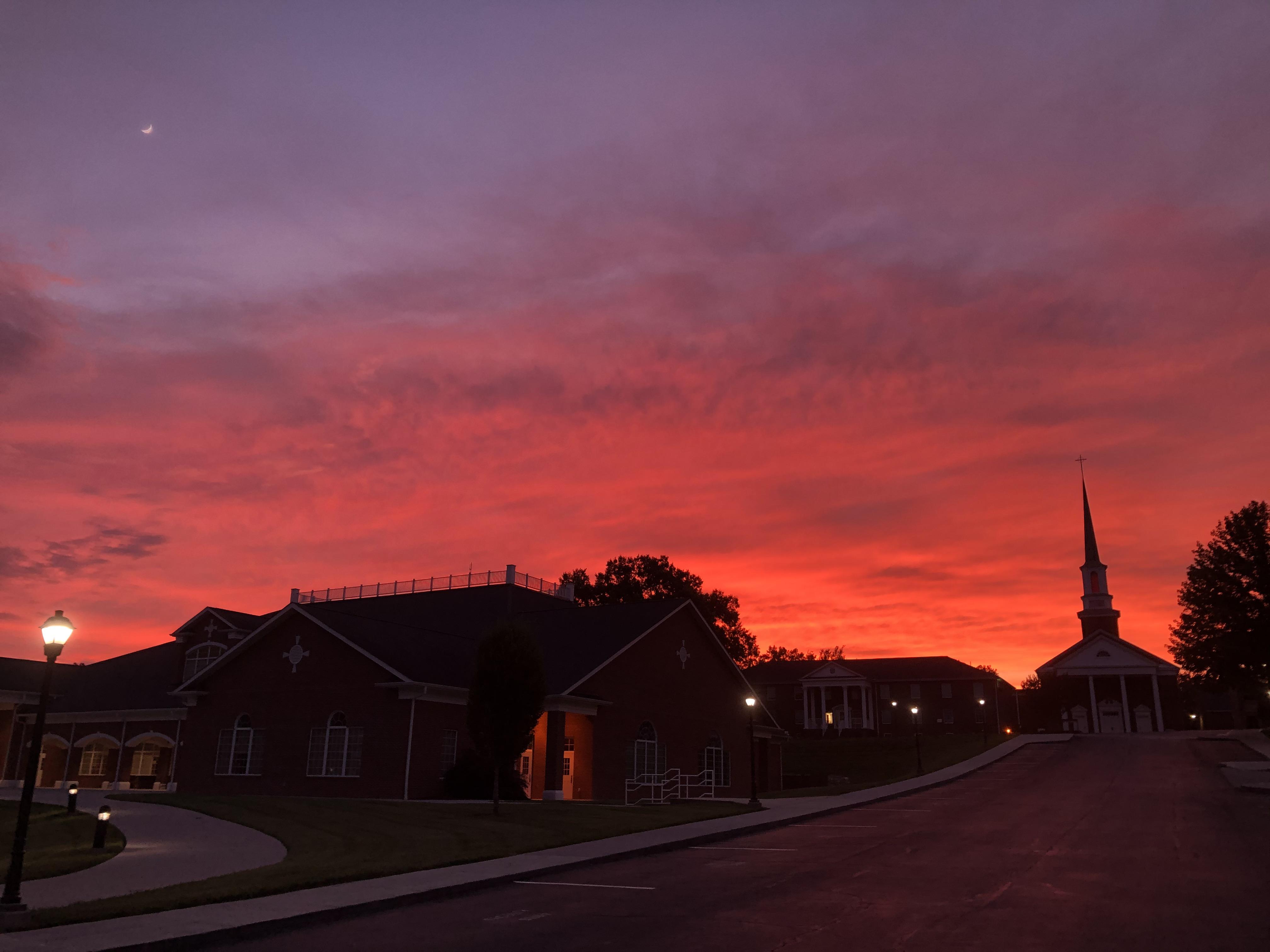 A fiery sunset over a chapel. | Scrolller