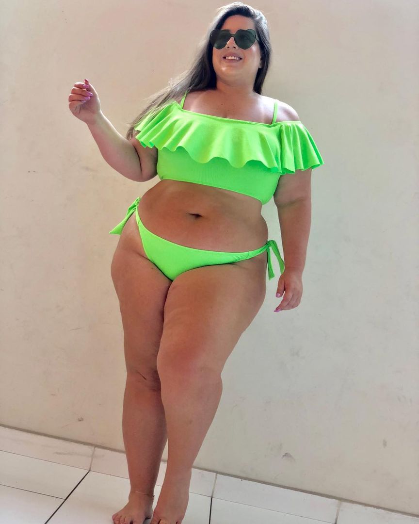Big thighs and a soft belly in a bright green bikini | Scrolller