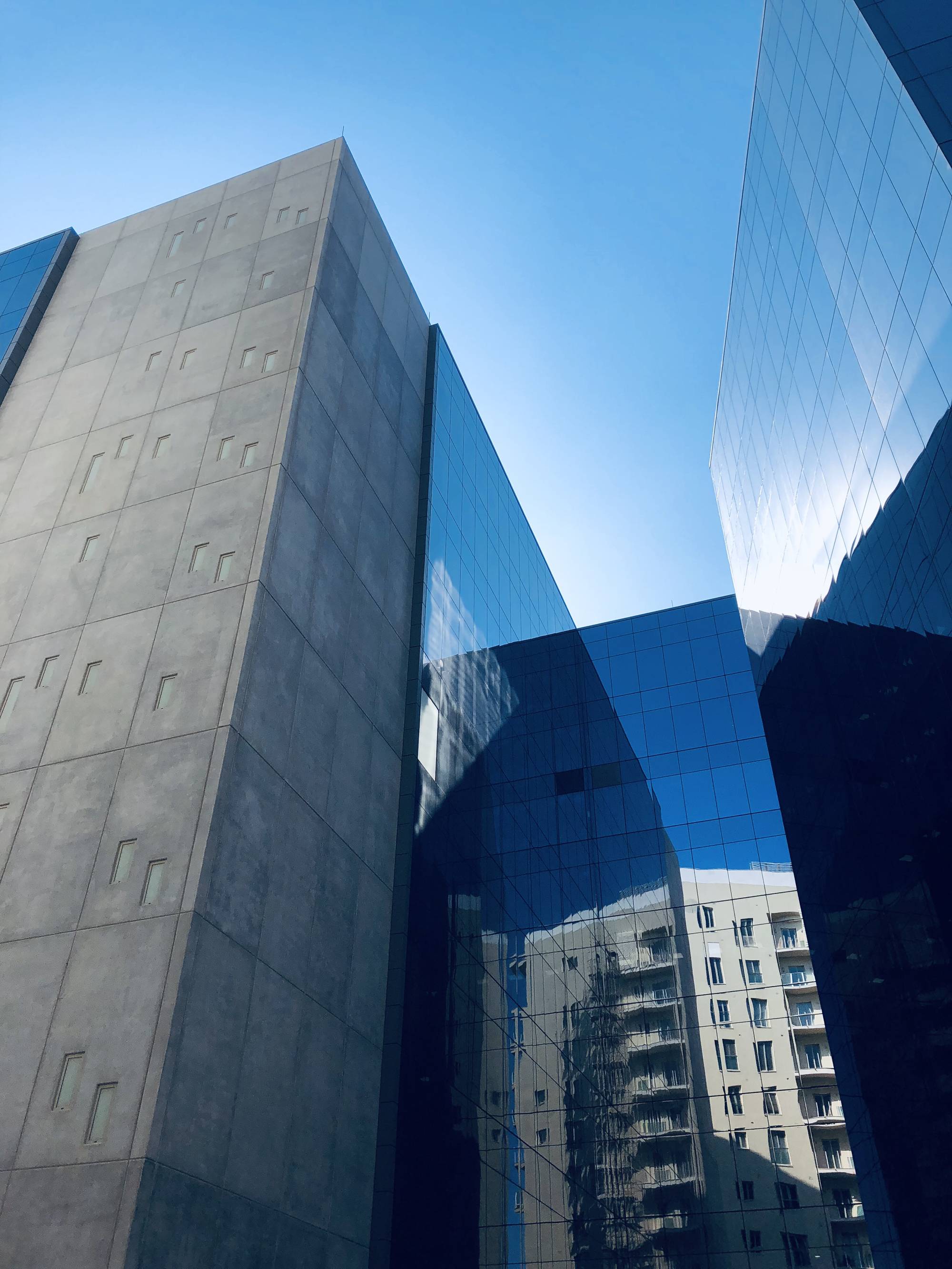 Blue sky reflect on a building | Scrolller