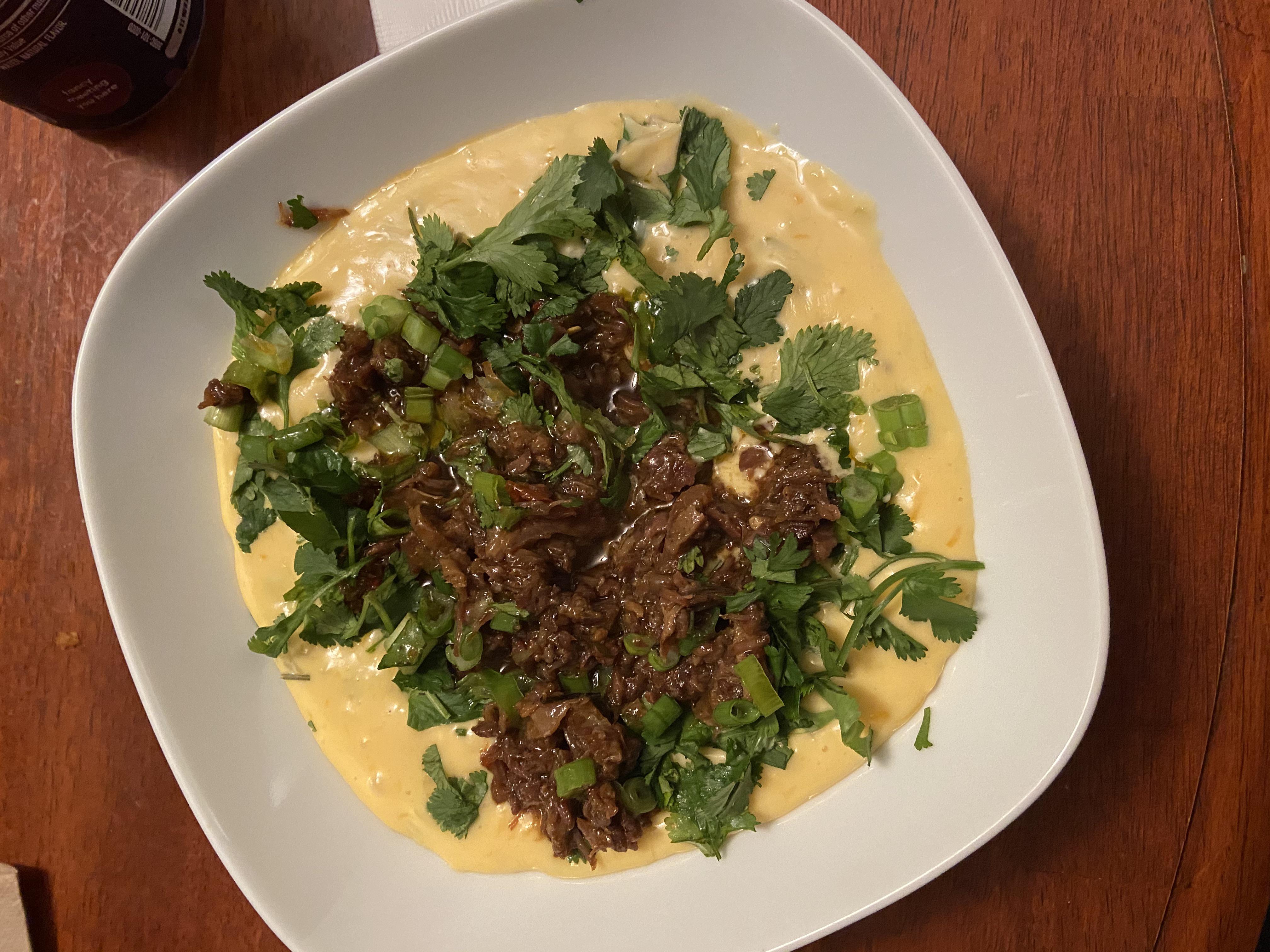 Braised short ribs on top of homemade queso for the super bowl | Scrolller