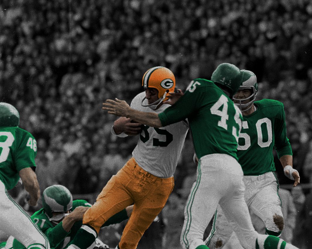 Chuck Bednarik and other Philadelphia Eagles tackle unknown Packers player , 1961, partial ...