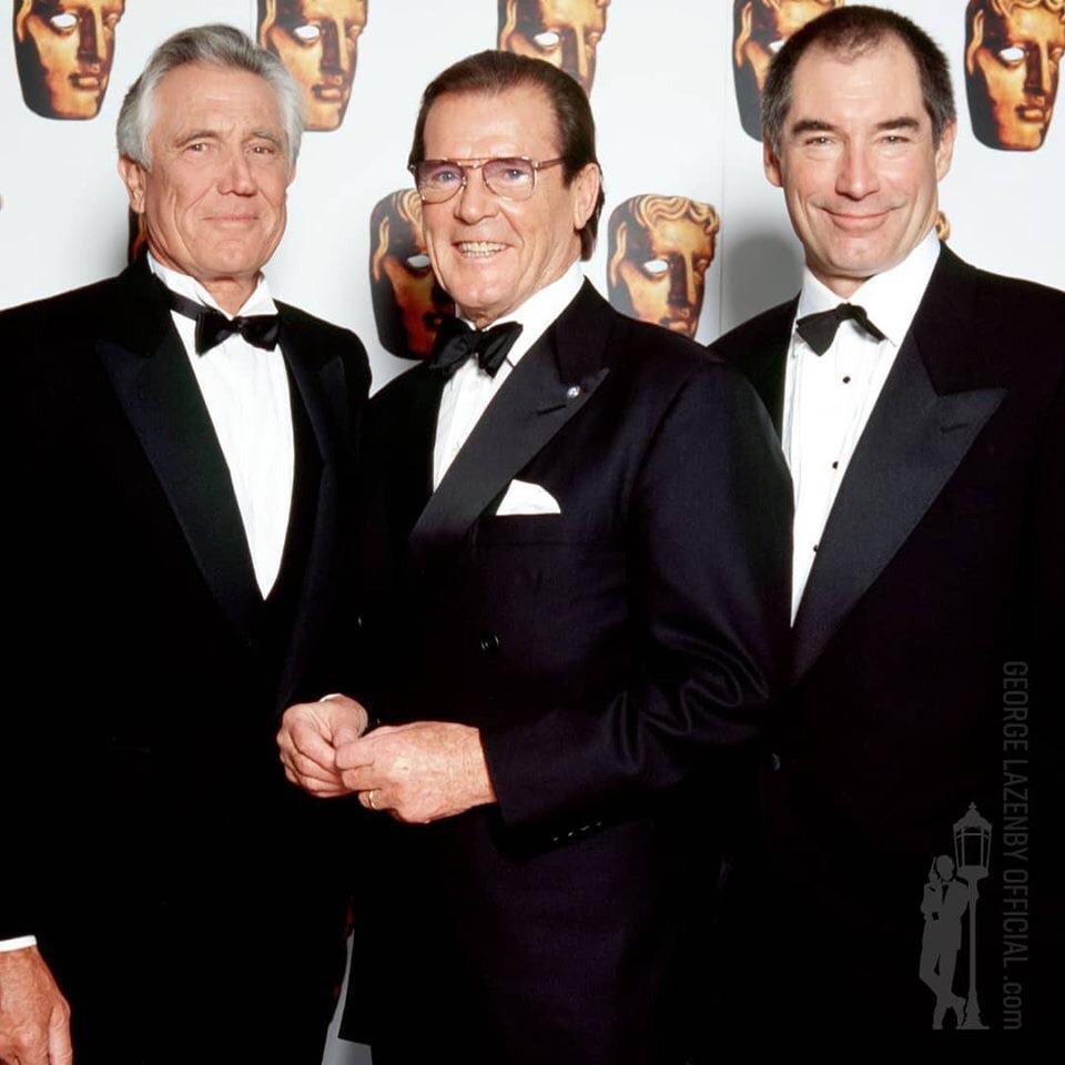George Lazenby, Roger Moore, and Timothy Dalton in 2002. | Scrolller