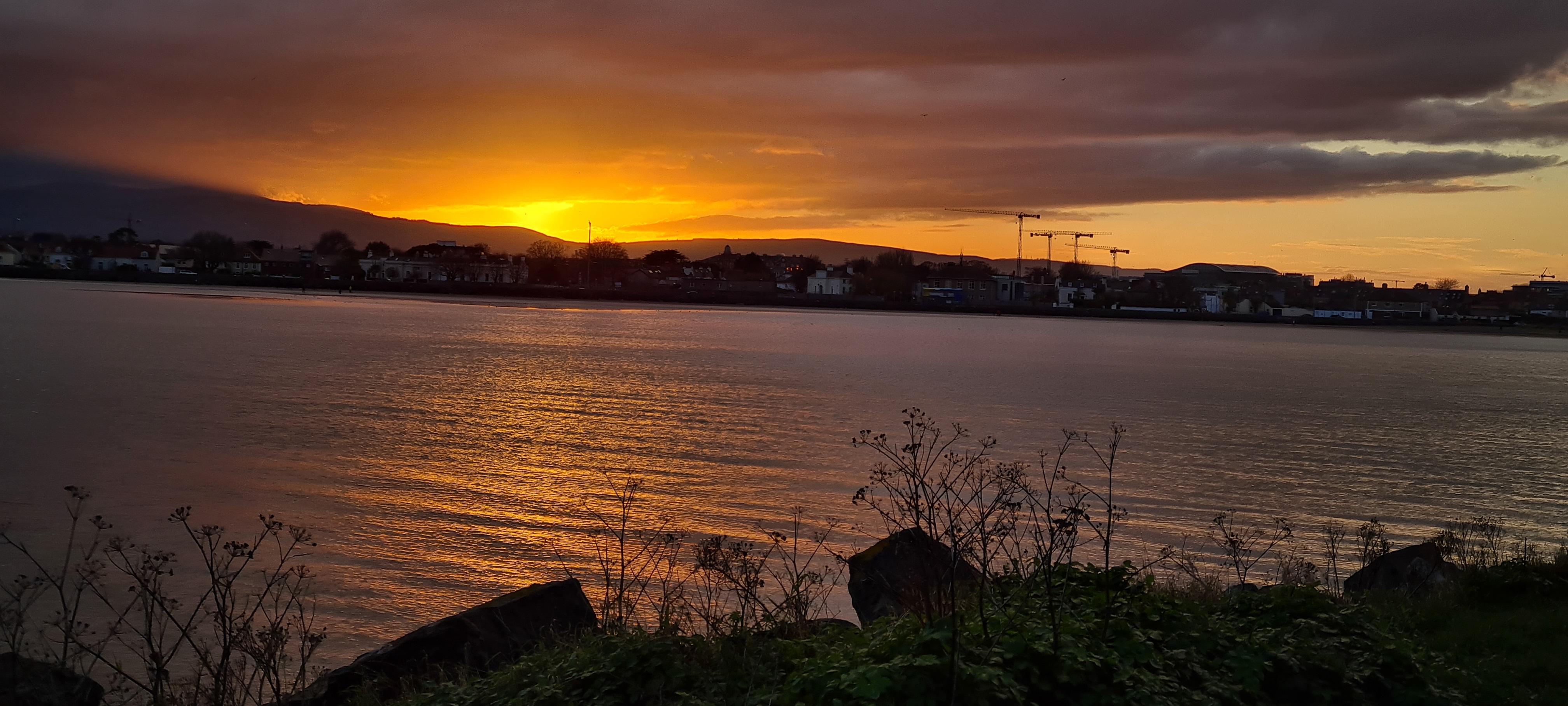 Golden sunset at the Poolbeg beach | Scrolller