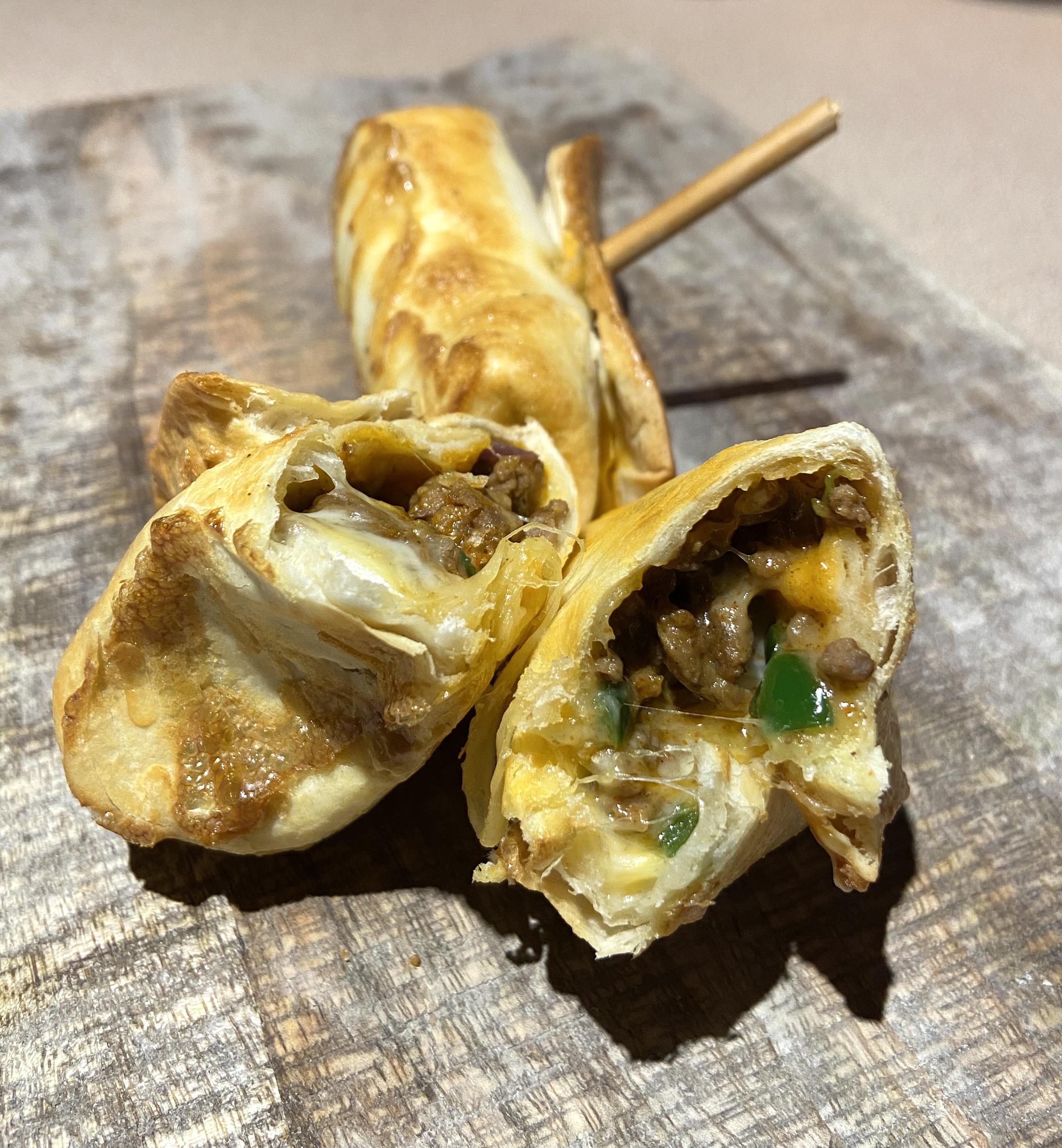 Homemade mini fried tortillas with cheese, beef, jalapeño, and onion dipped in olive oil and egg ...