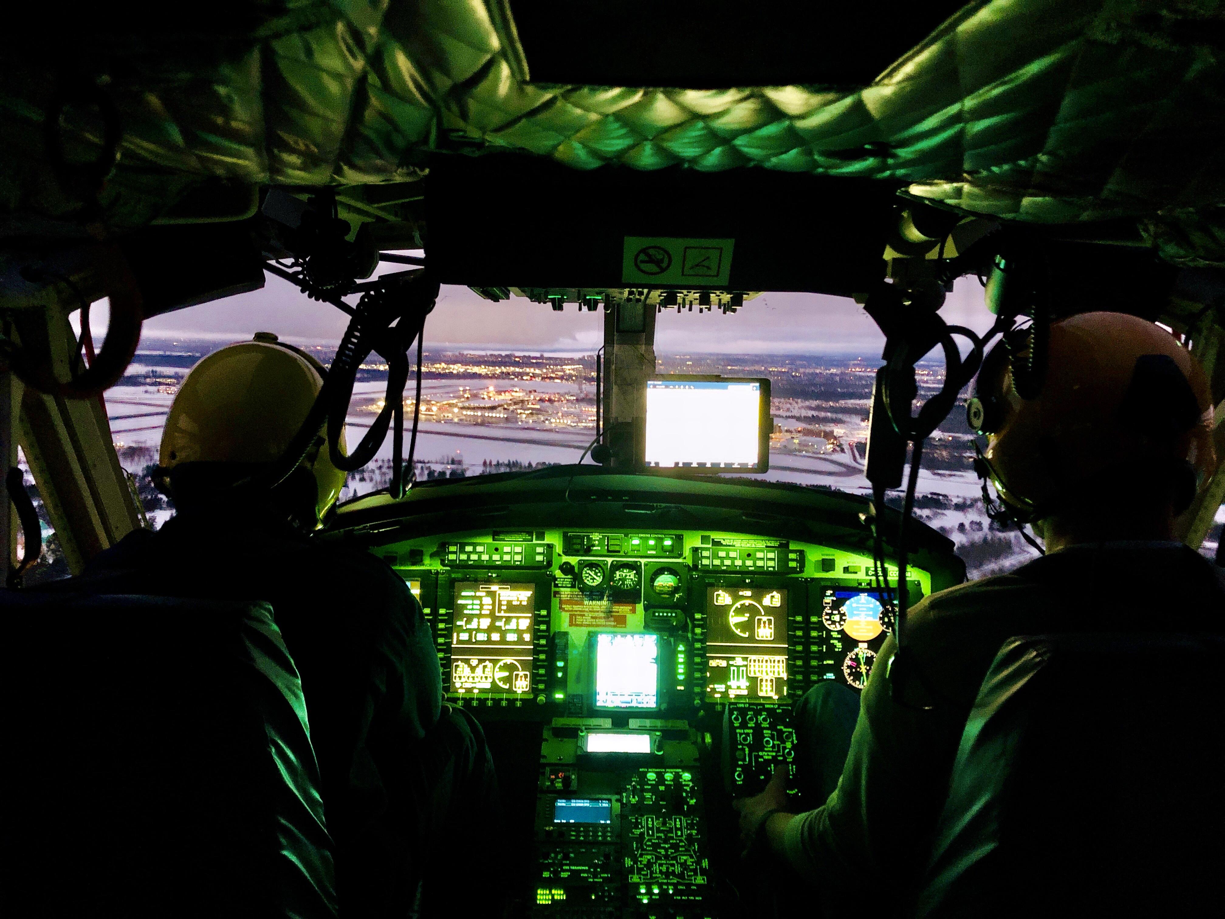 I hear we are doing 412EPI cockpits lit up in the evening. CCG948 short final in to YOW. | Scrolller