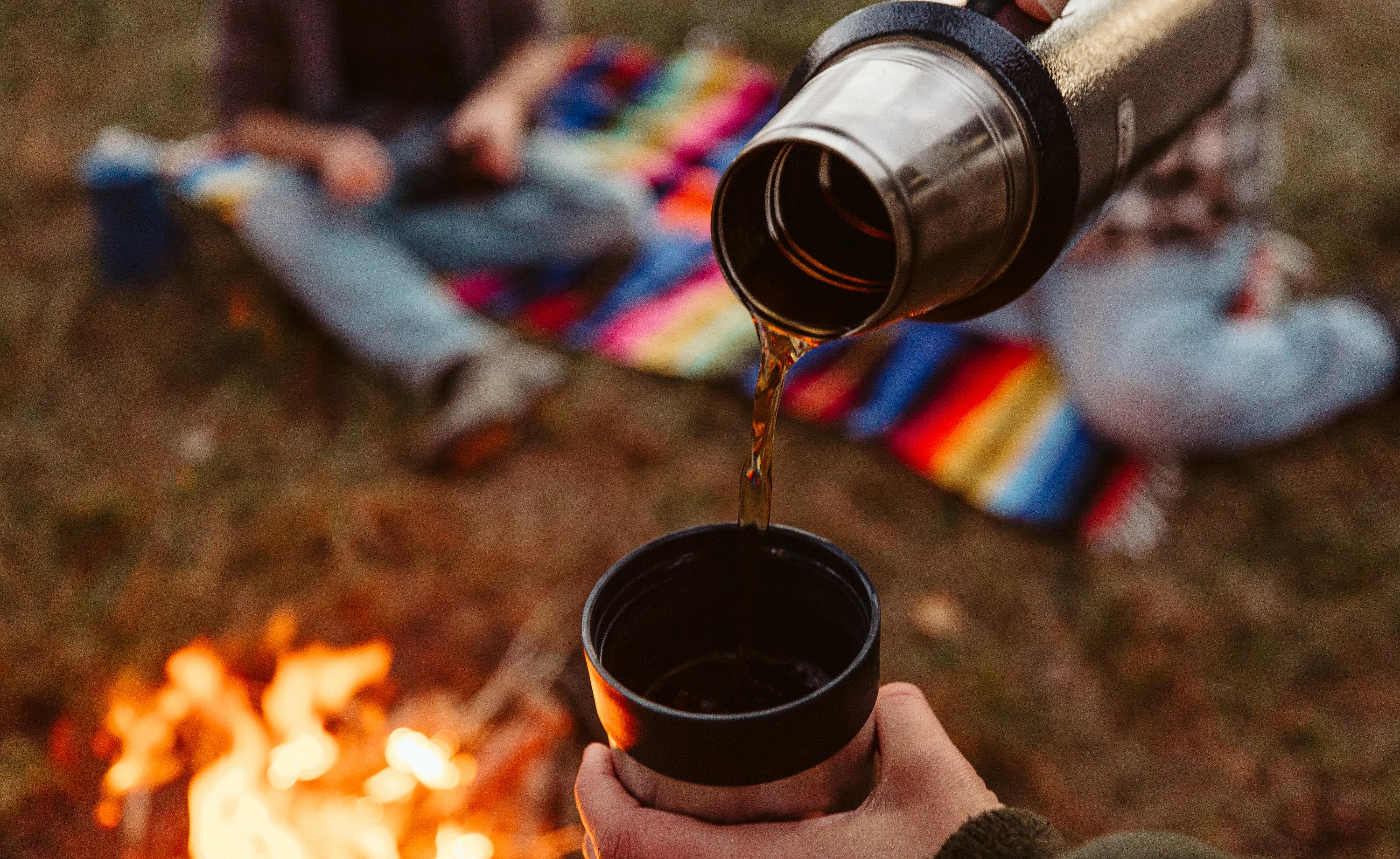 In the forest relaxing by the campfire | Scrolller