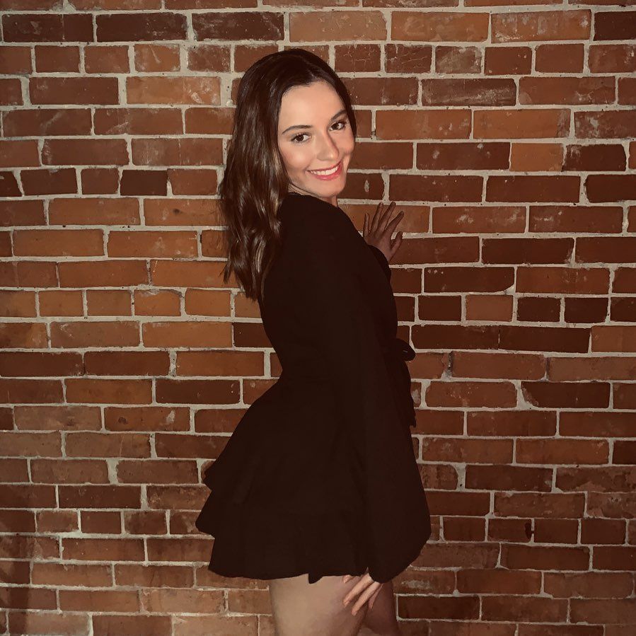 LBD in front a Red Brick Wall | Scrolller